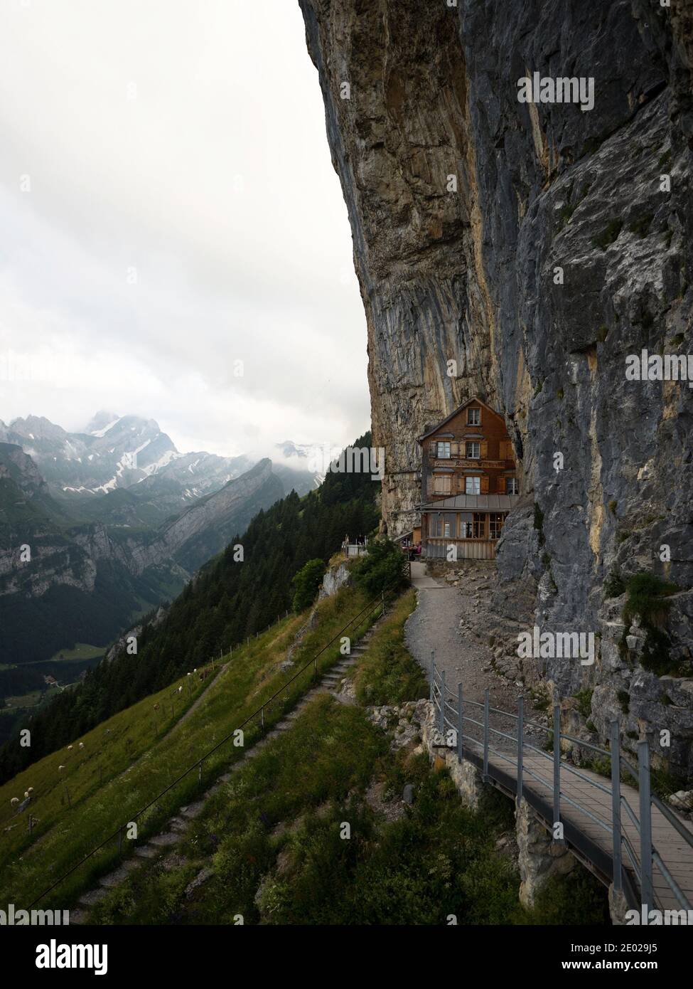 Famous guesthouse Aescher-Wildkirchli built into limestone cliff wall ...
