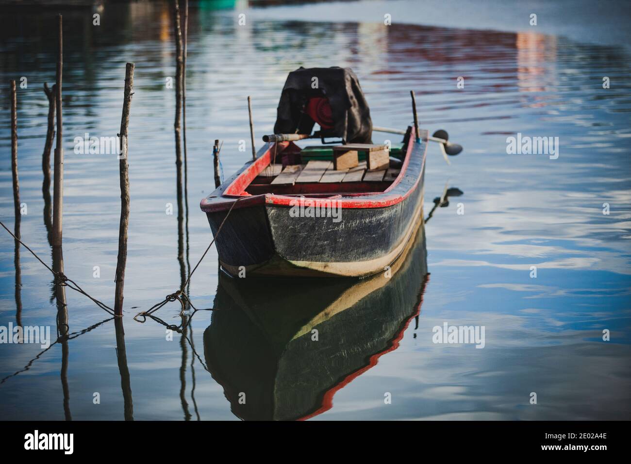old wooden boat floating over plain water Stock Photo - Alamy