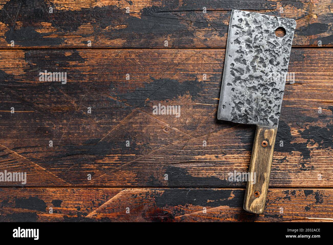 Vintage butcher meat cleaver. Dark wooden background. Top view. Copy ...