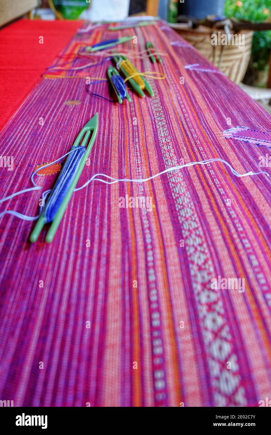 Traditional weaving loom with colorful cotton fiber being woven into ...