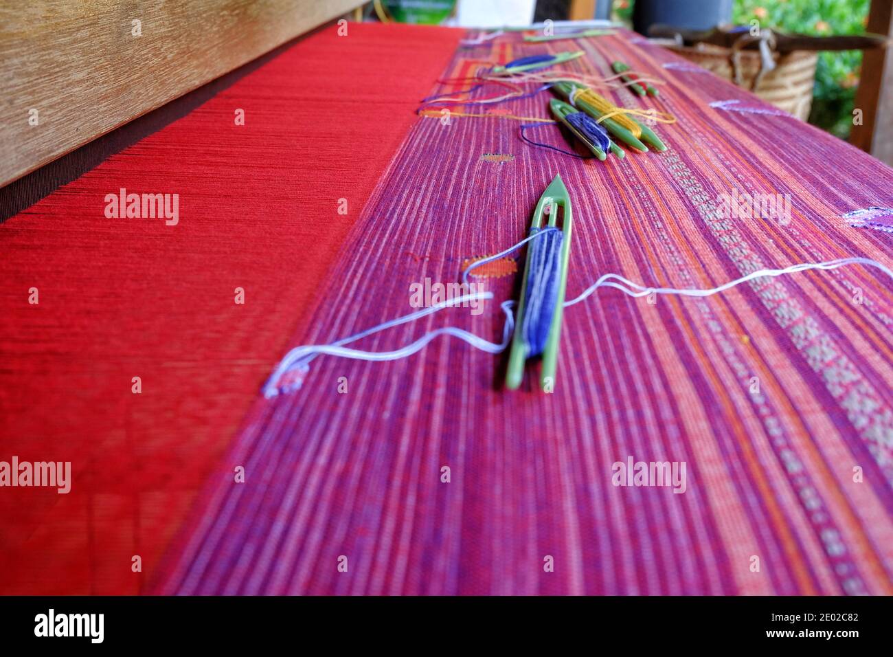 Traditional weaving loom with colorful cotton fiber being woven into ...