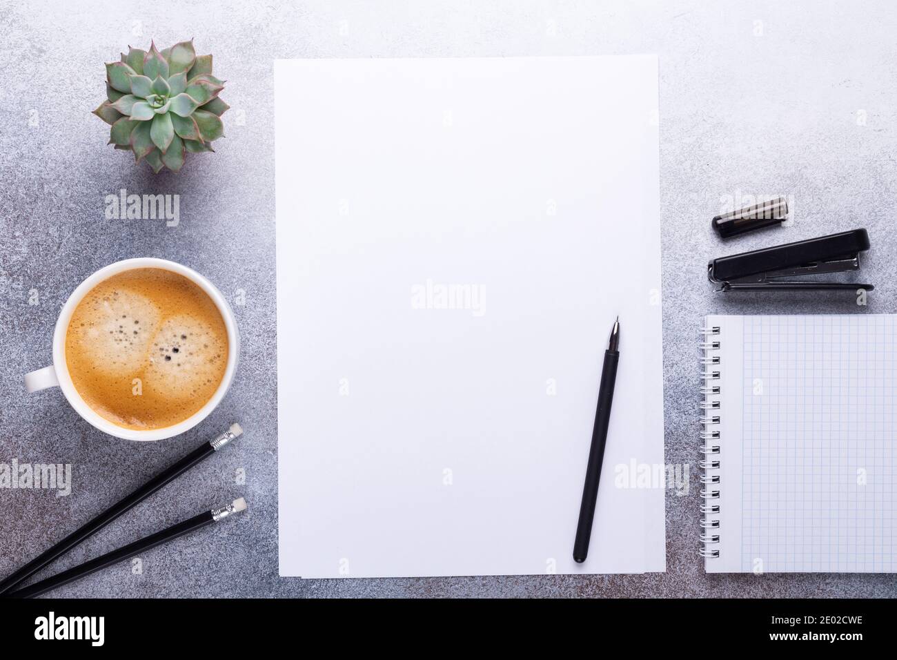 Office workplace with blank paper, cup of coffee, note pad and pen. Top ...