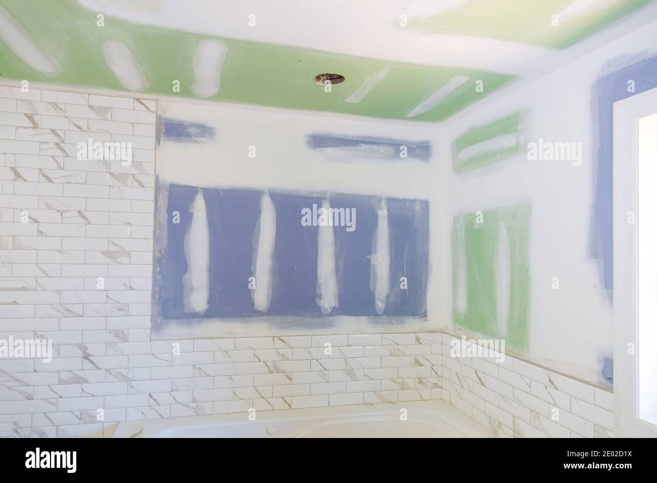 Construction installing ceramic tile on reconstruction of bathroom ...