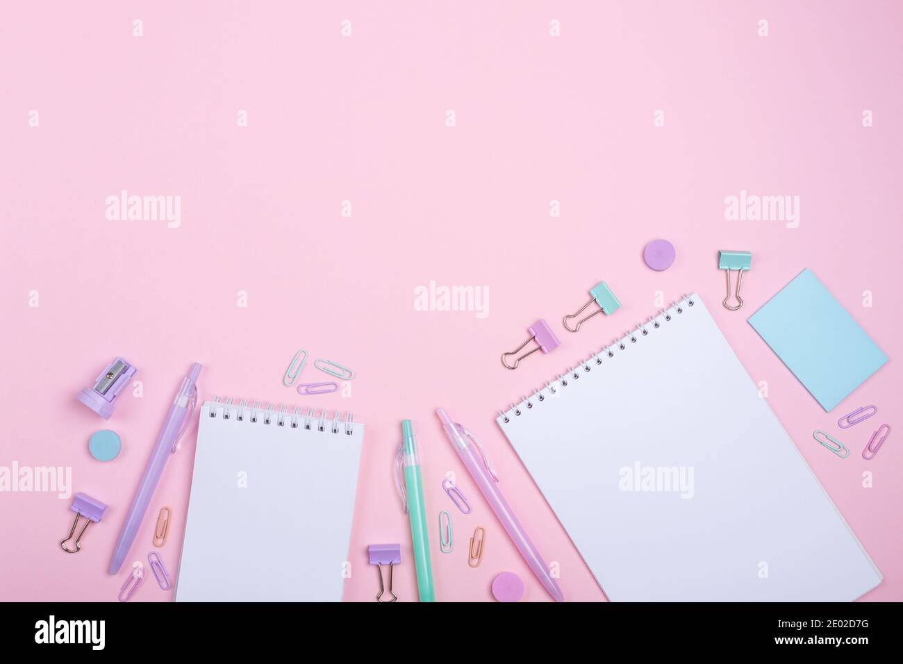 School background with notebook and pastel colorful study accessories ...