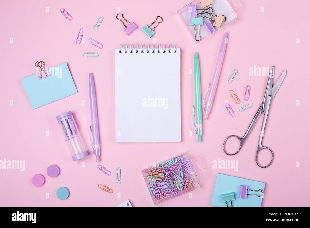 School background with notebook and pastel colorful study accessories ...