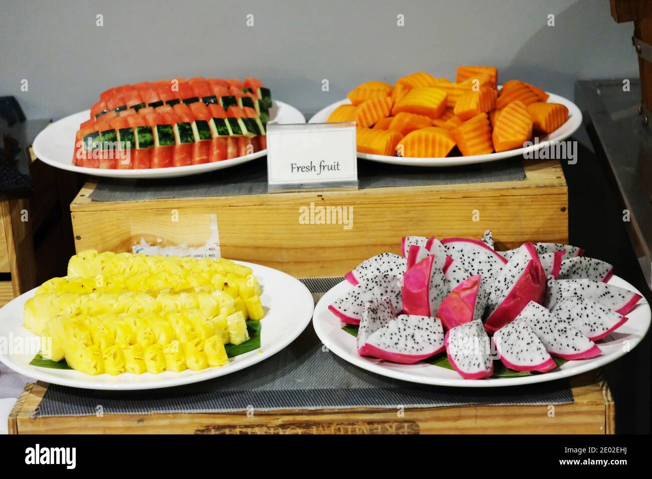 Four types of fresh fruits in white plates Stock Photo - Alamy