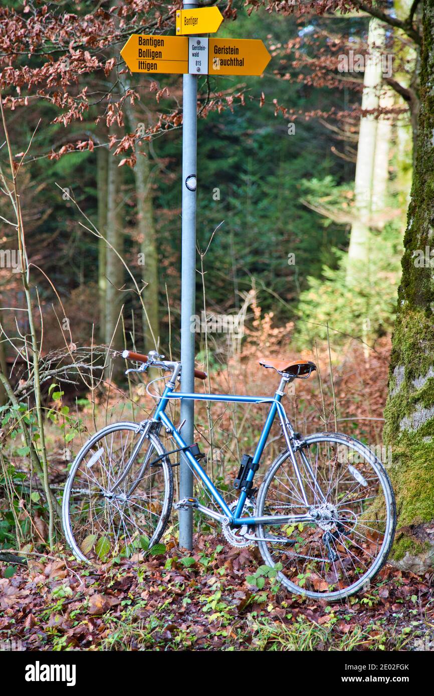 a blue bike and a signpost Stock Photo - Alamy