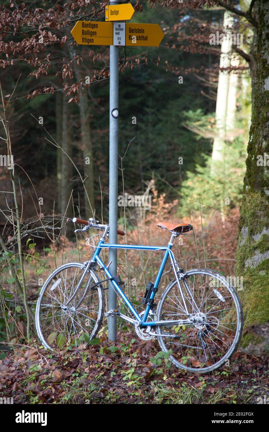 a blue bike and a signpost Stock Photo - Alamy