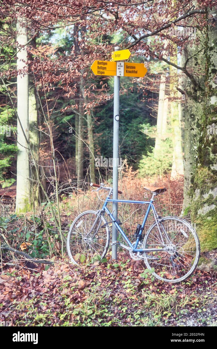 a blue bike and a signpost Stock Photo - Alamy