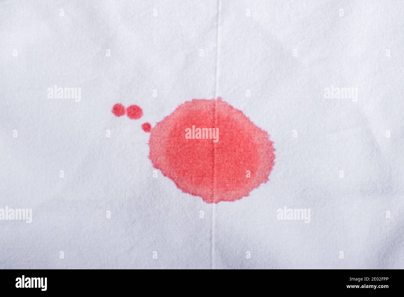 Drops of blood on a white cloth background Stock Photo - Alamy