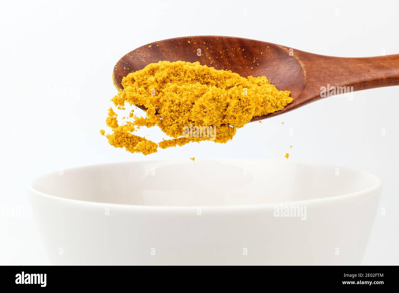 Curry powder on white background Stock Photo - Alamy