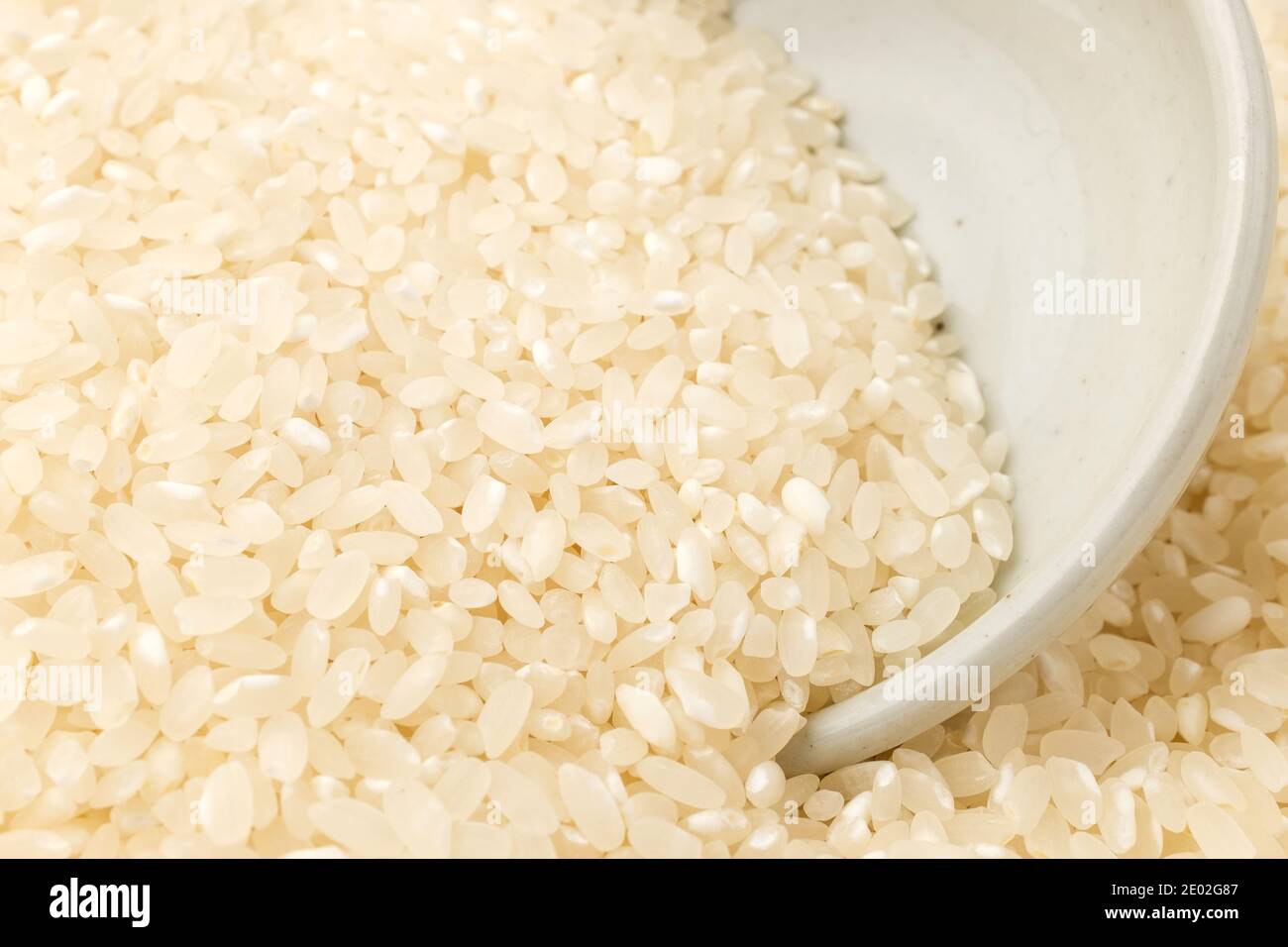 White rice on white background Stock Photo - Alamy