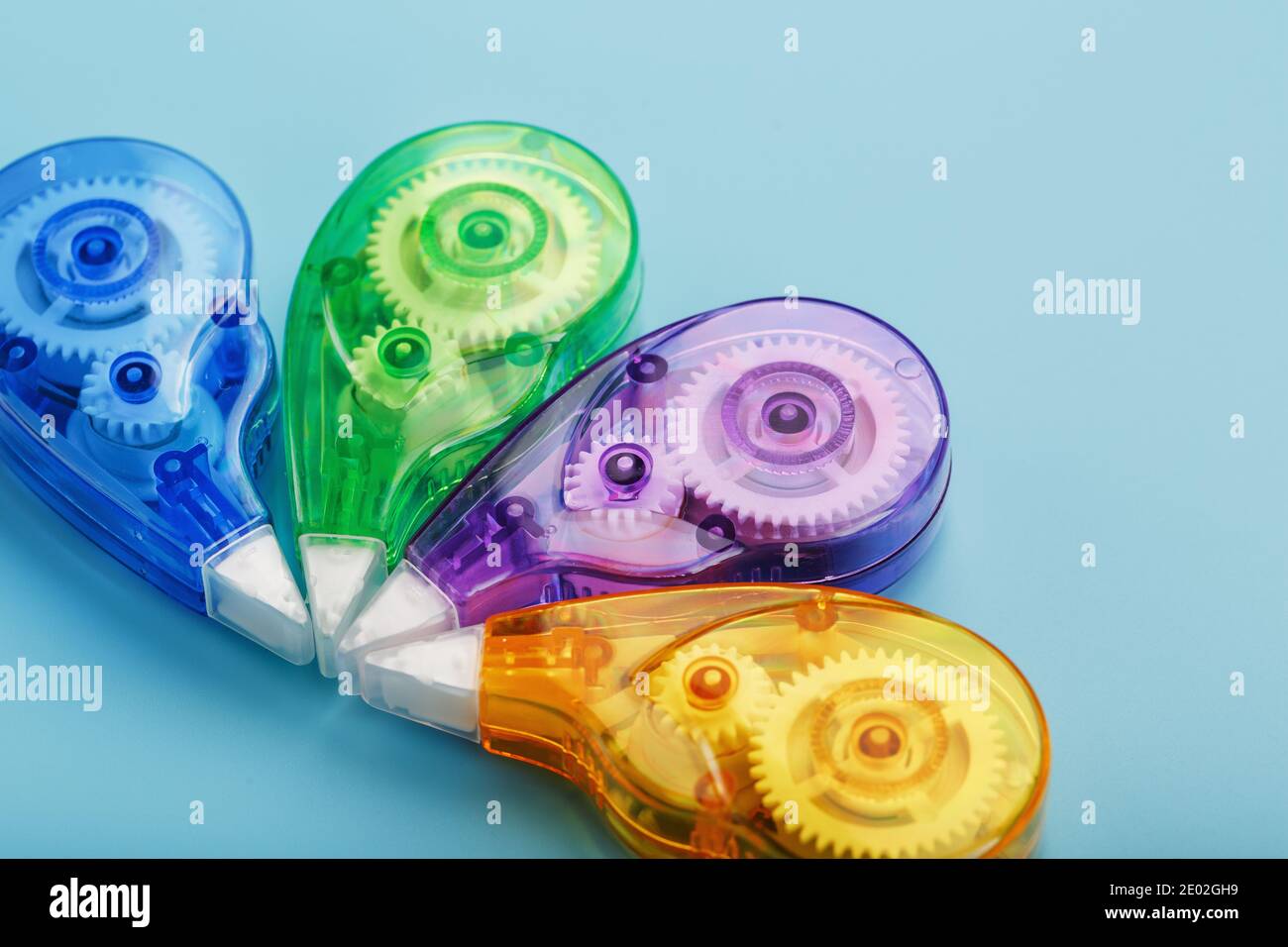 Multi-colored Stationery correction tapes on a blue background. Free ...