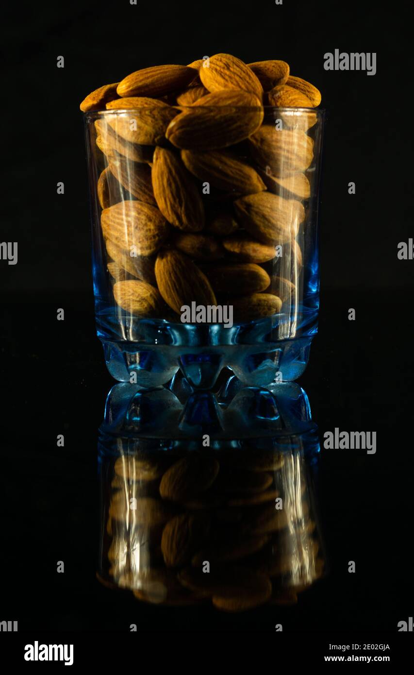 Protein-rich Raw Badam stacked in a glass on a dark table Stock Photo ...