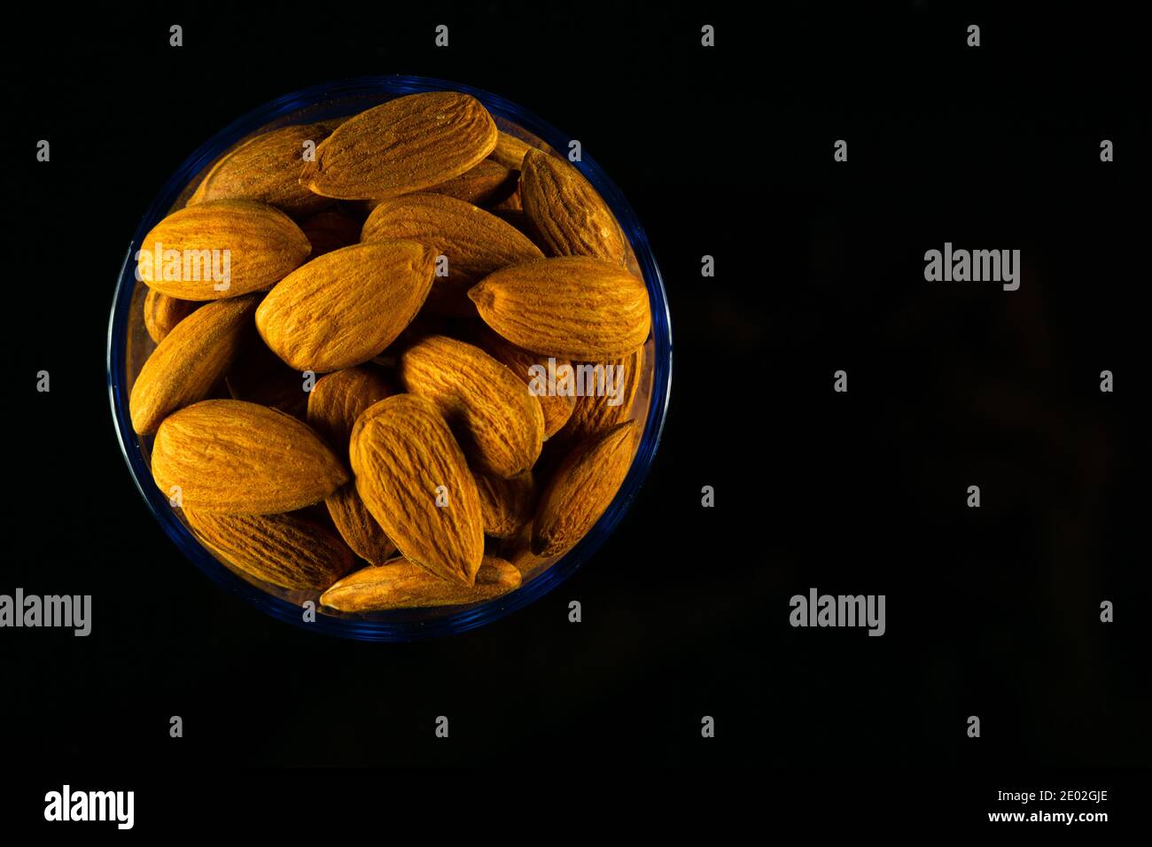 Protein-rich Raw Badam stacked in a glass on a dark table Stock Photo ...
