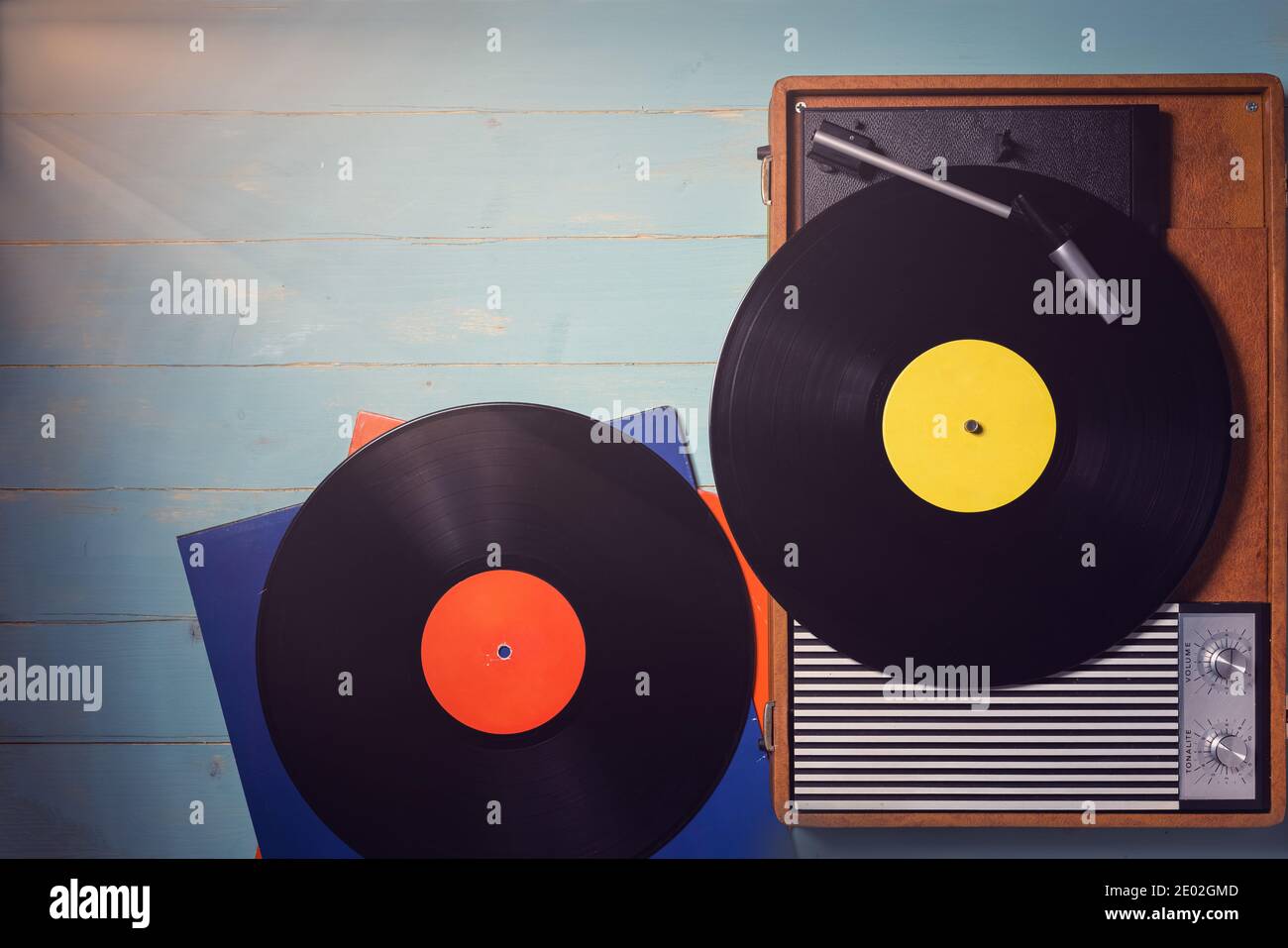 Old record player from the 70s with a vinyl records on vintage wooden ...