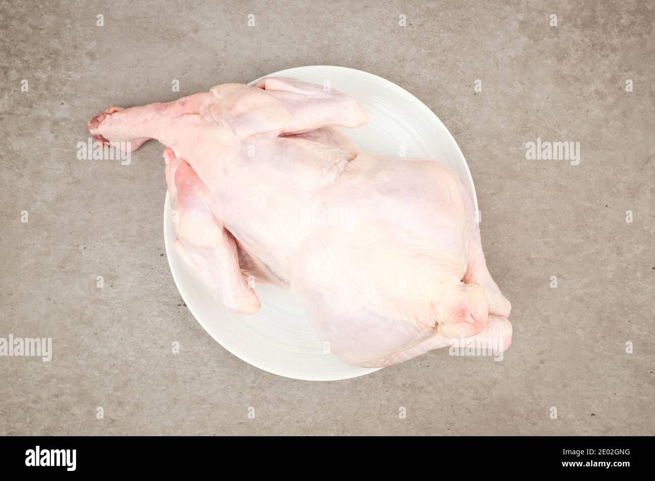 Raw chicken on rough background Stock Photo - Alamy