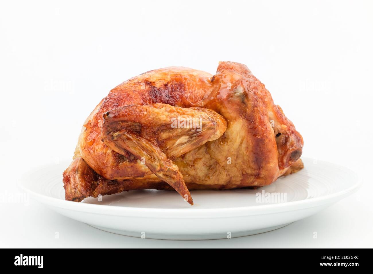 Roast chicken on white background Stock Photo - Alamy