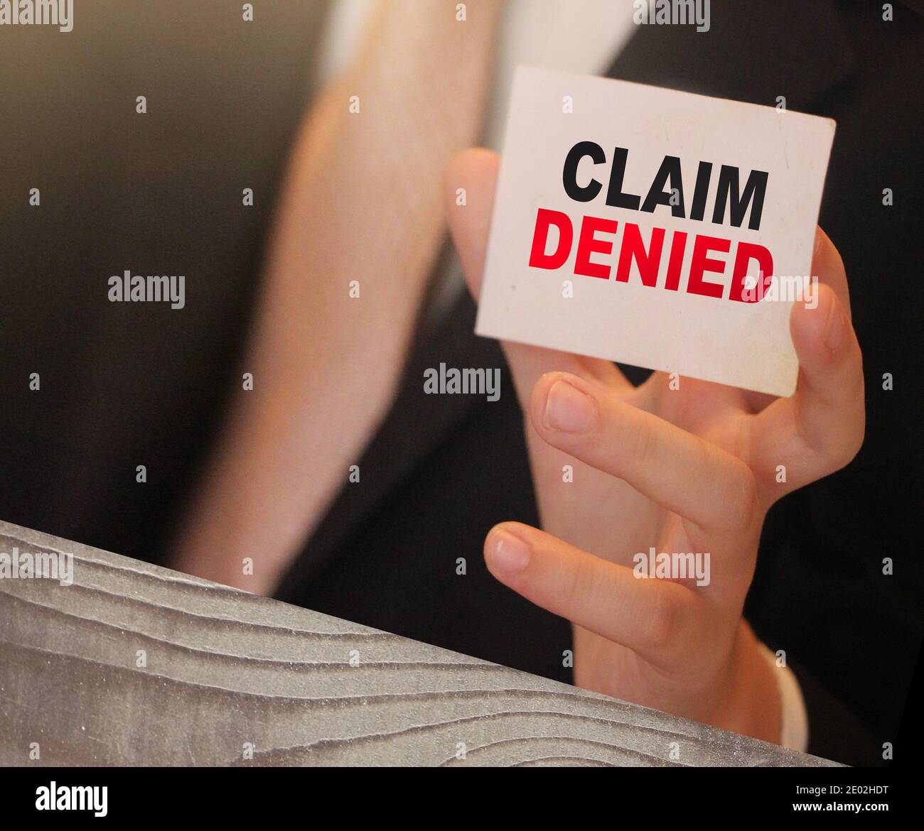Claim Denied words on a card in hand of businessman. Business agreement ...
