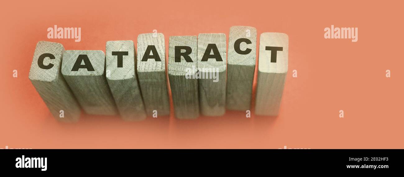 Cataract word made with building blocks on light cyan. Eye healthcare ...