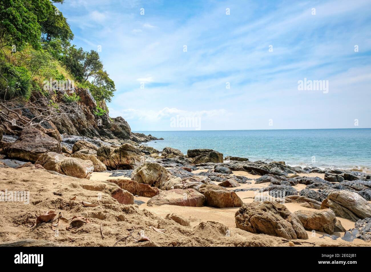 Beautiful rocky beach. Coast with tropical greenery. Turquoise sea and ...