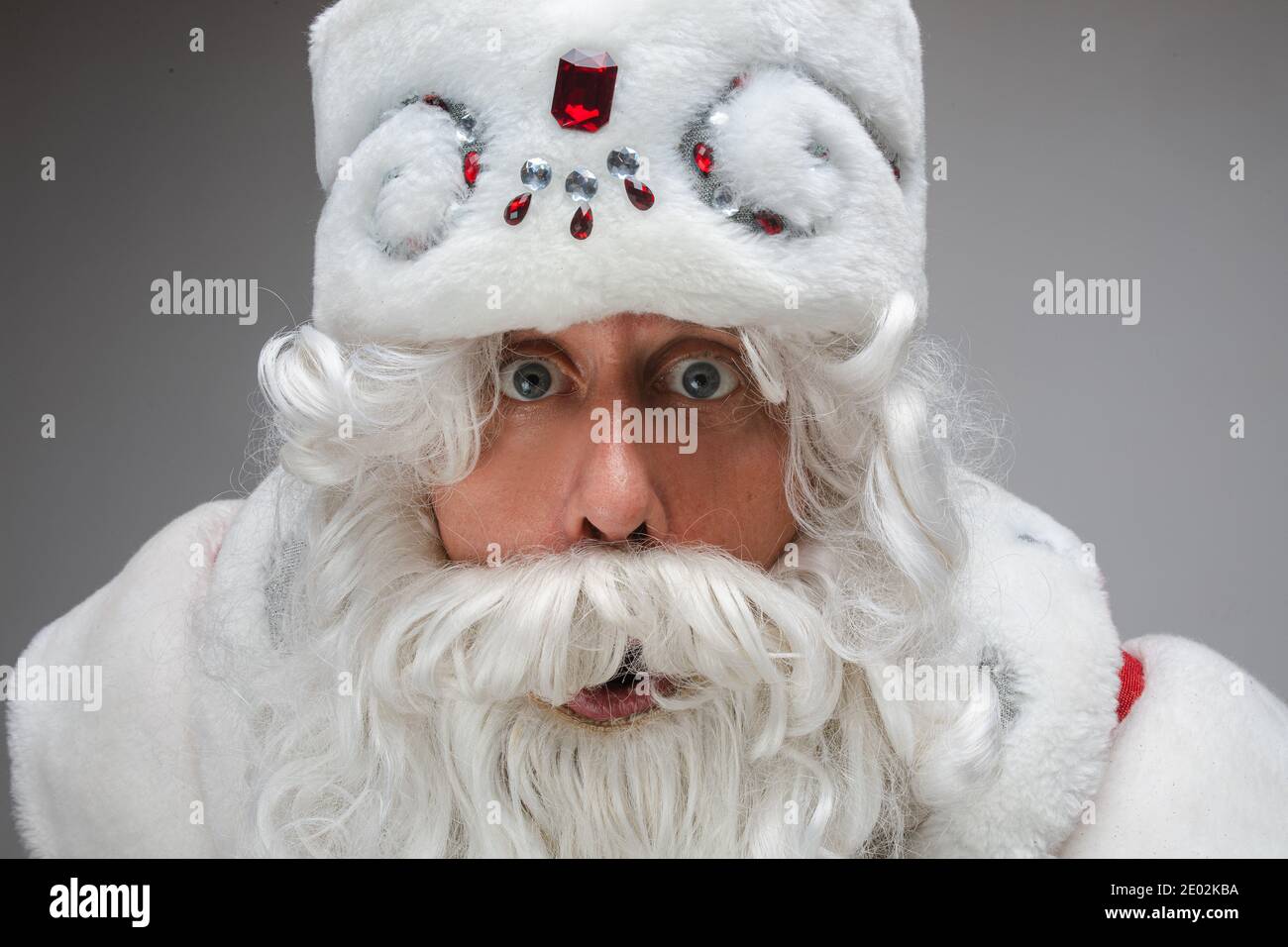 Close up portrait of studio surprised shocked Santa Claus on gray ...