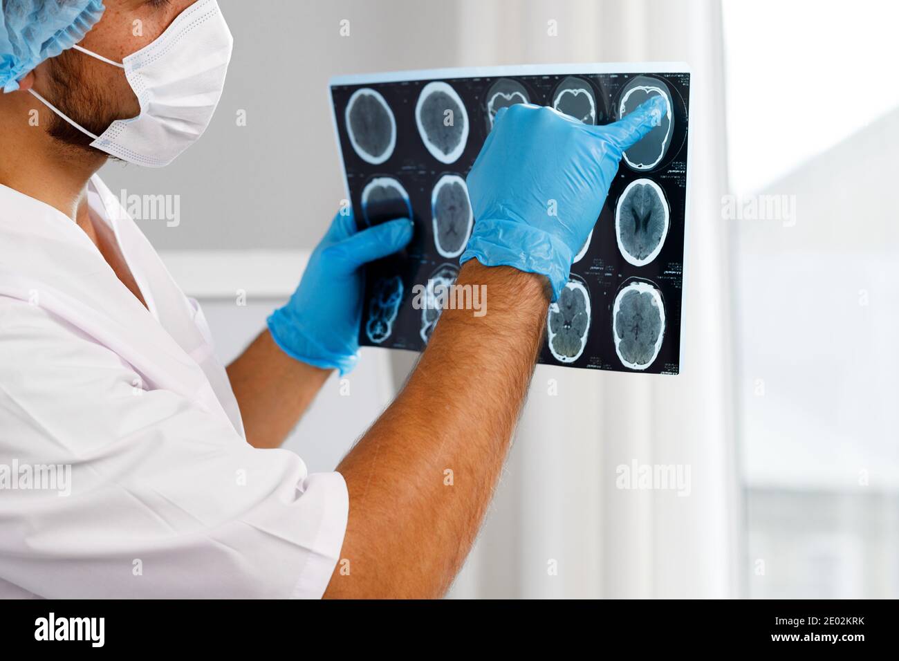 Male doctor examines MRI brain scan of a patient Stock Photo - Alamy