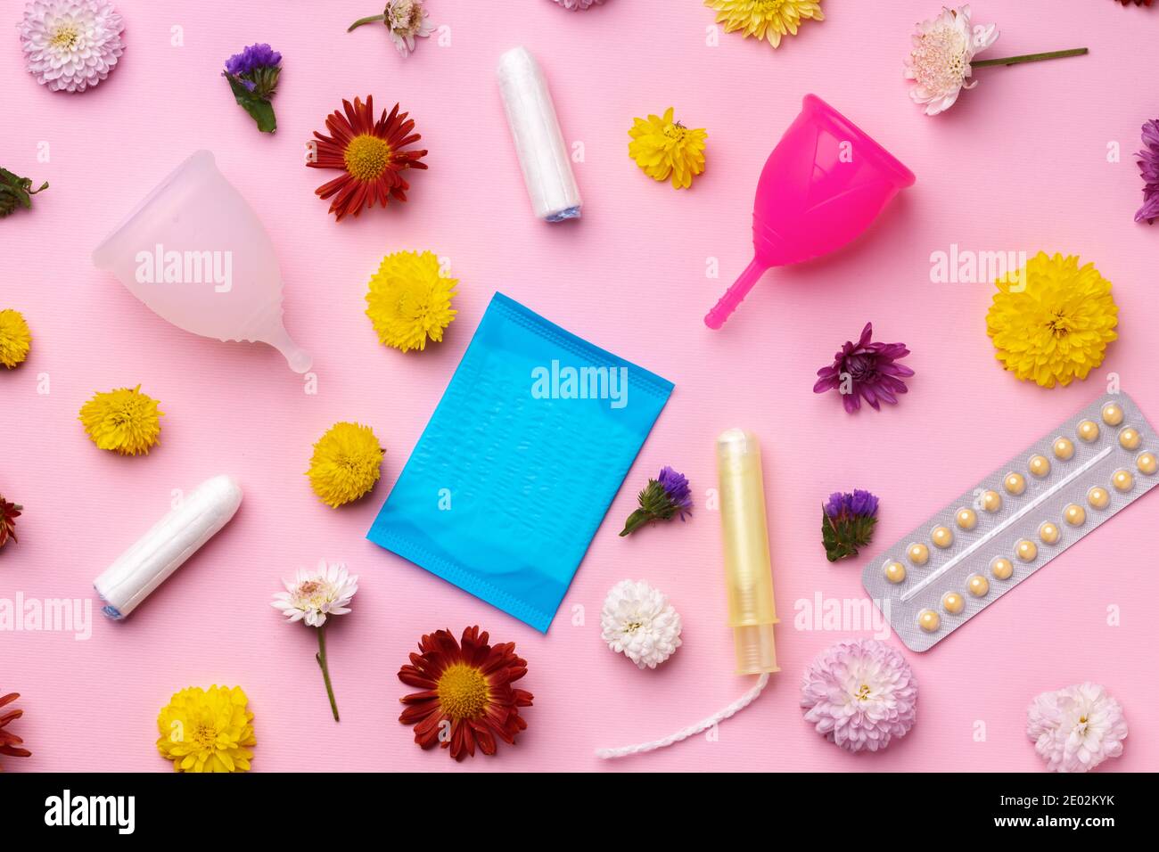 Menstrual cup, oral contraceptives and medical tampons with flowers top ...