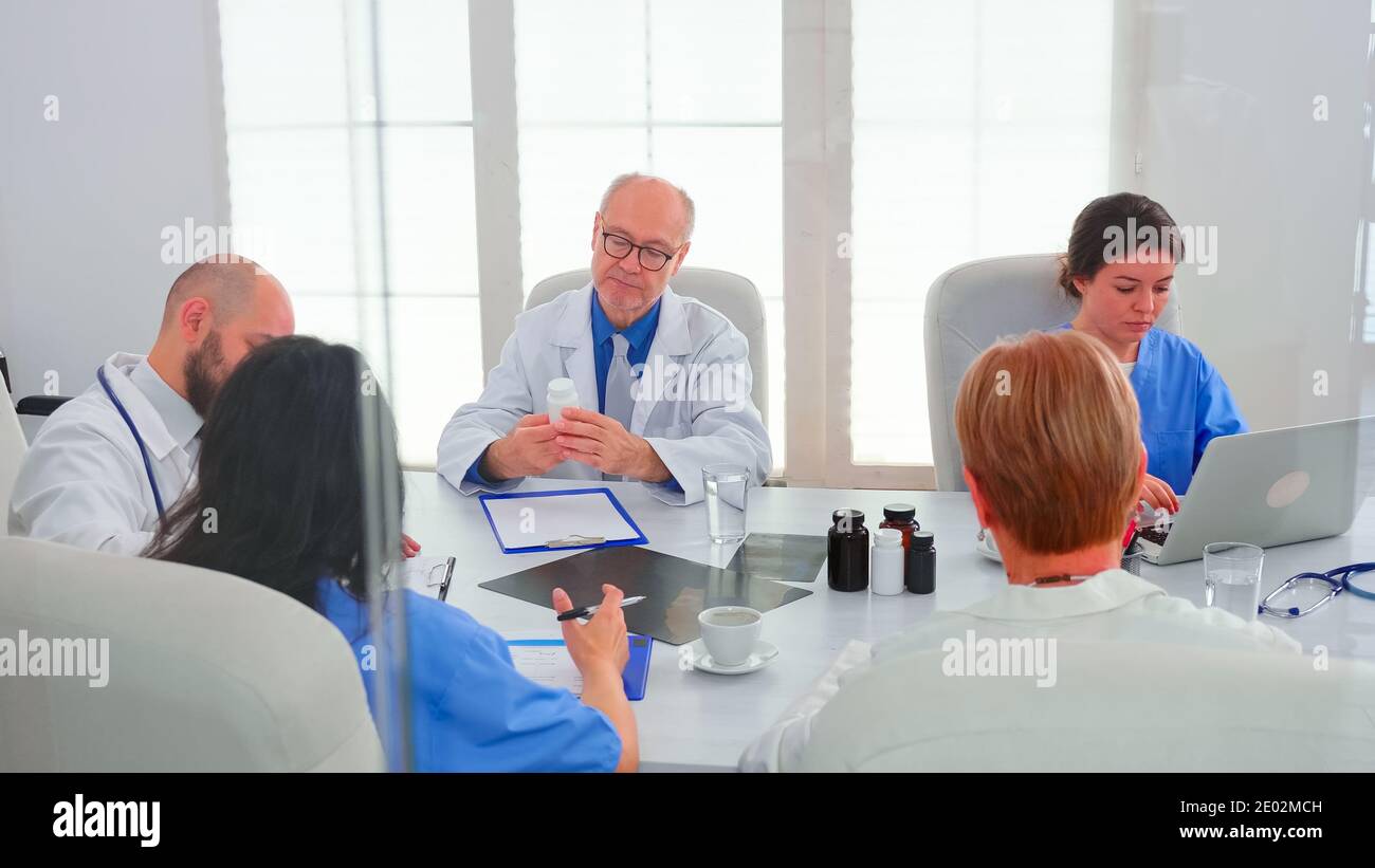 Concentrated medical team discussing looking for solutions together in ...