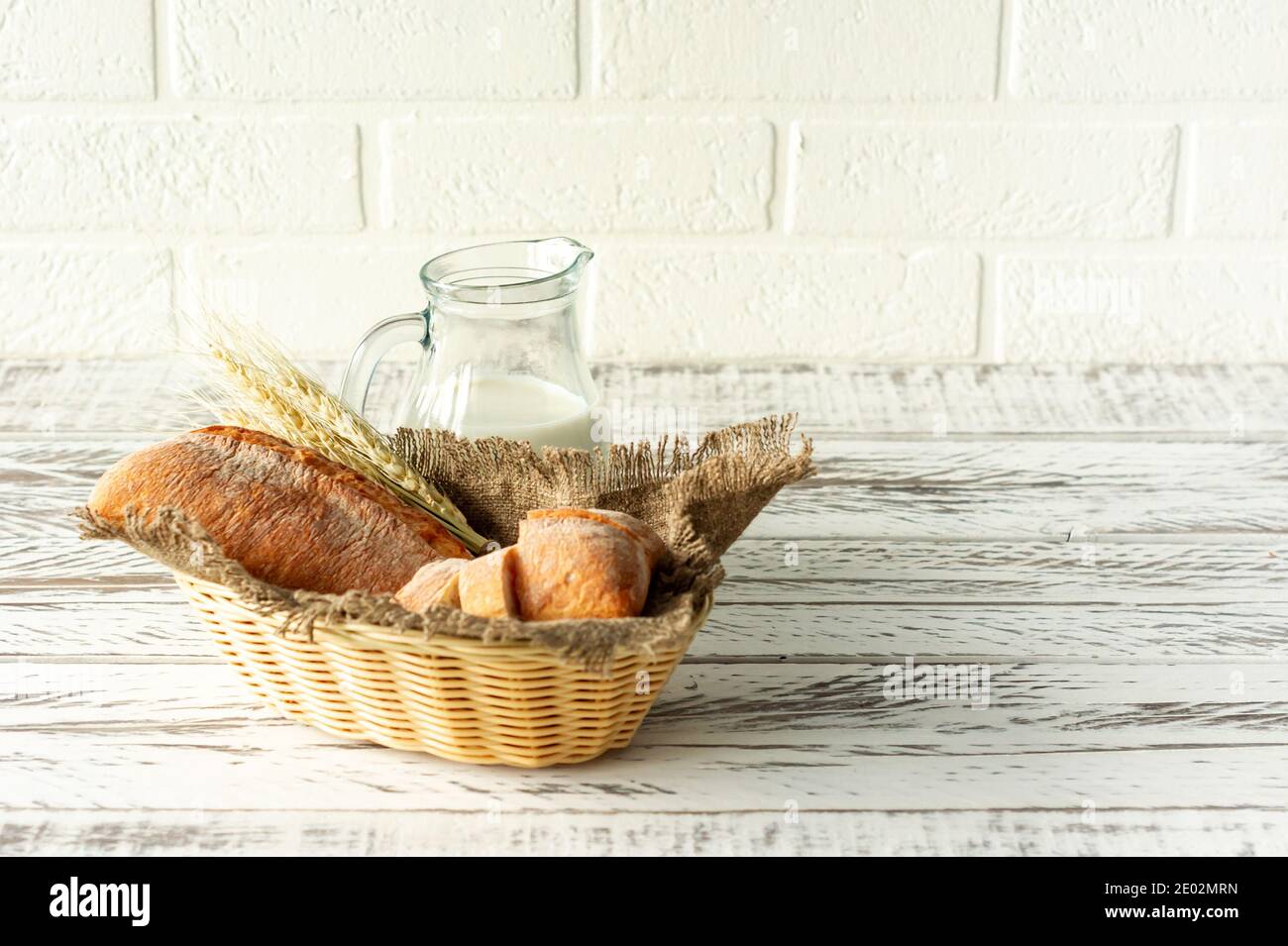 Composition of various baked products in basket on rustic background ...