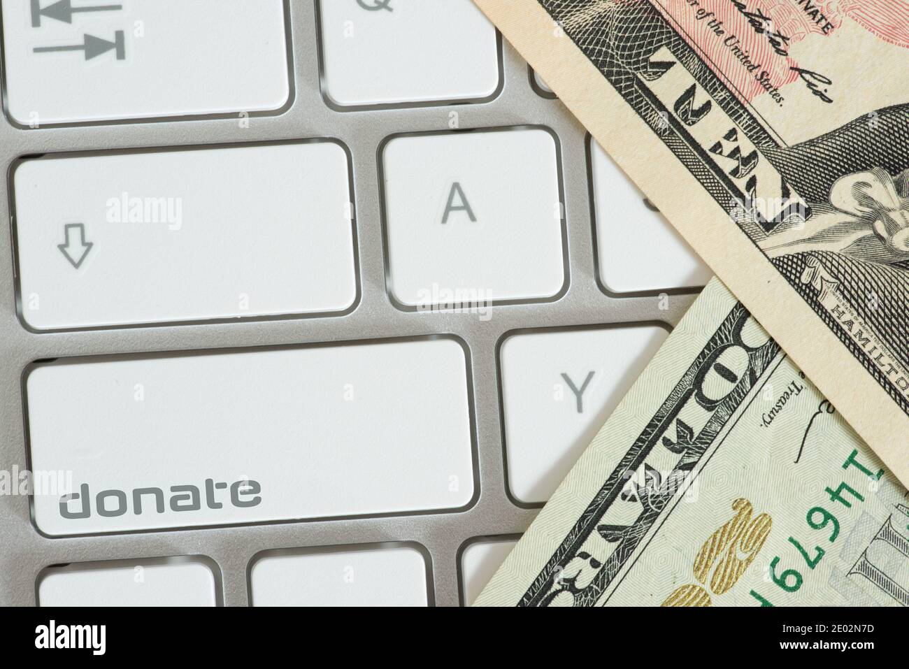 A computer, dollar bills and key for donations Stock Photo - Alamy