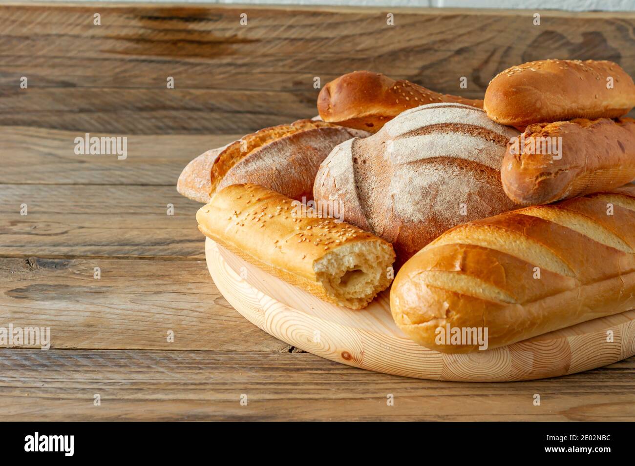 Types of homemade bread on the rustic wooden table. Homemade baked ...