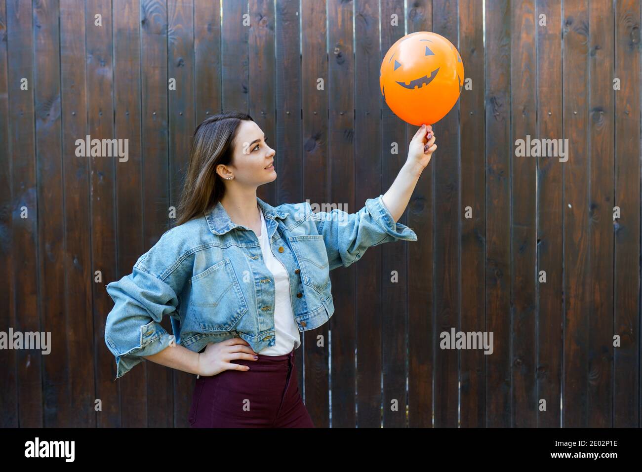 halloween autumn background with girl holding orange air ballon, copy ...