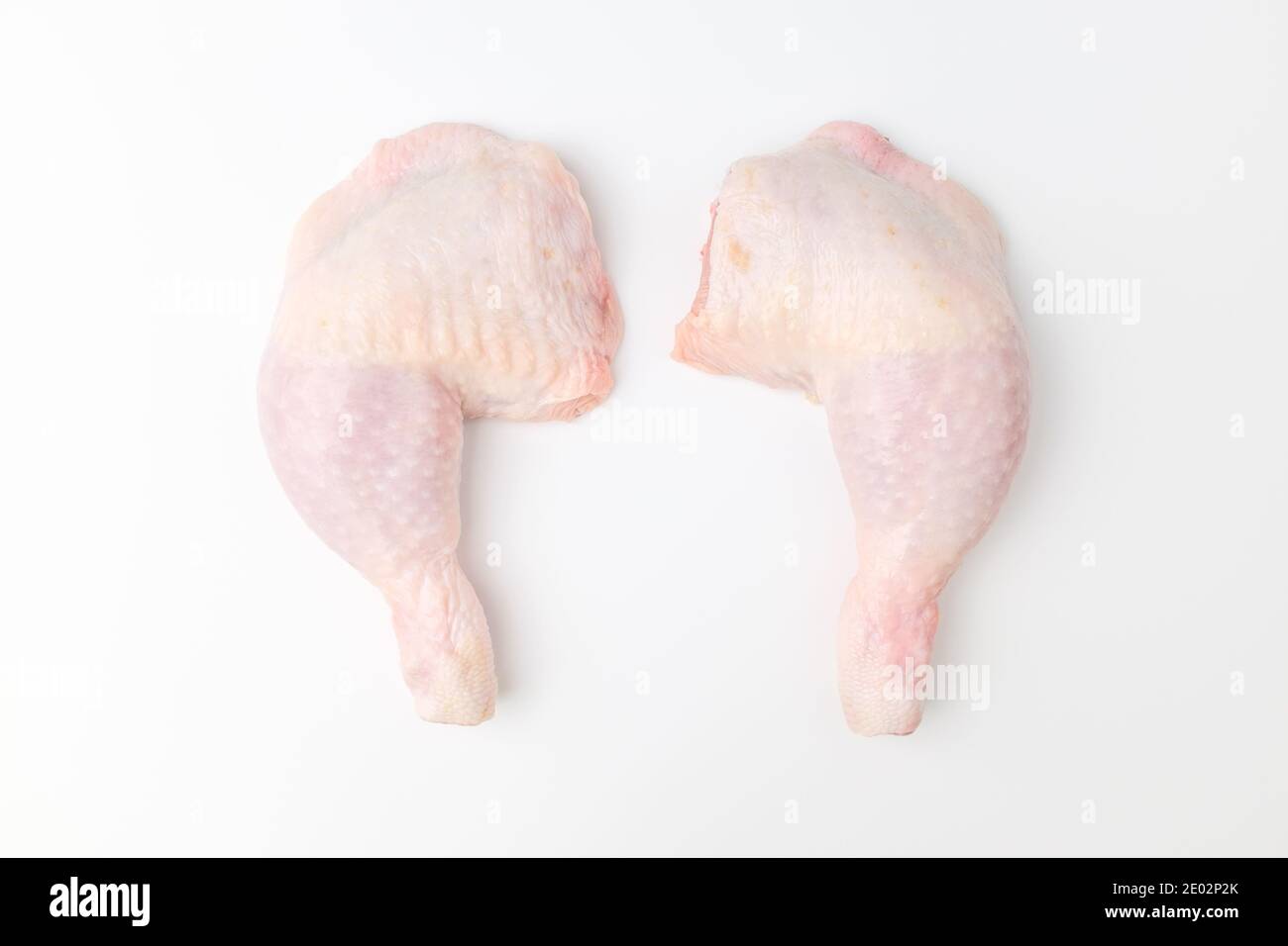 Trimmed chicken legs on a white background Stock Photo - Alamy