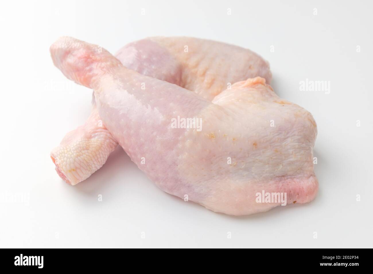 Trimmed chicken legs on a white background Stock Photo - Alamy