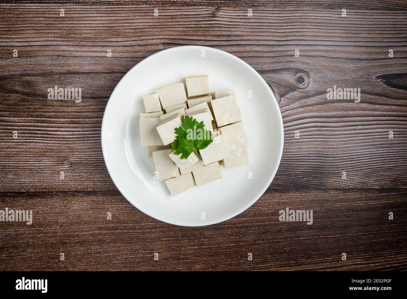 Diced Tofu in dish on wood background. full depth of field. vegan food ...
