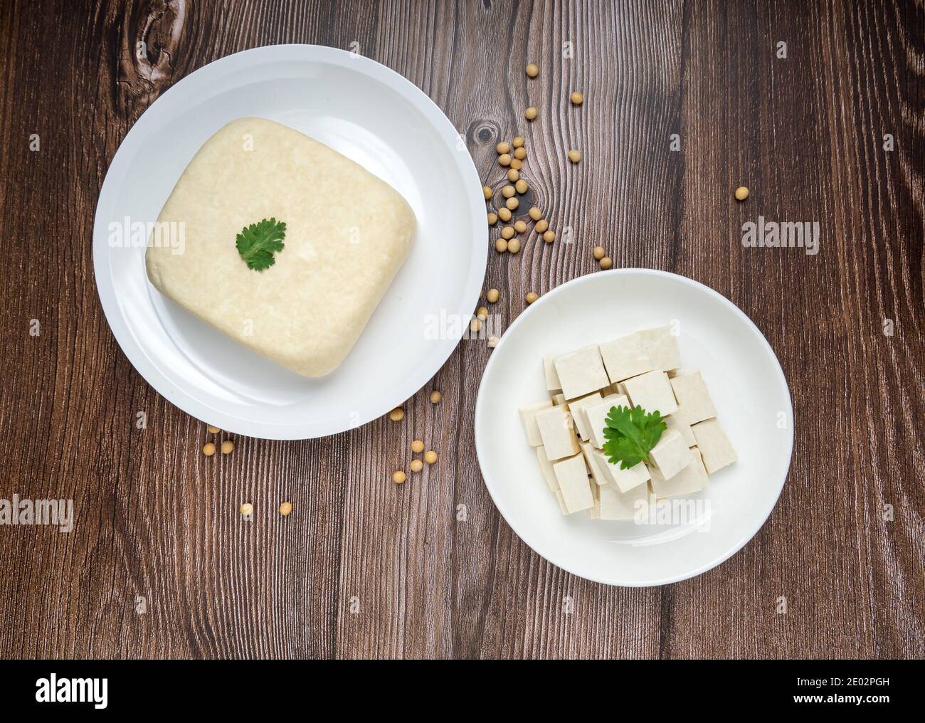 Whole fresh tofu in white plate and Diced Tofu in dish on wood ...