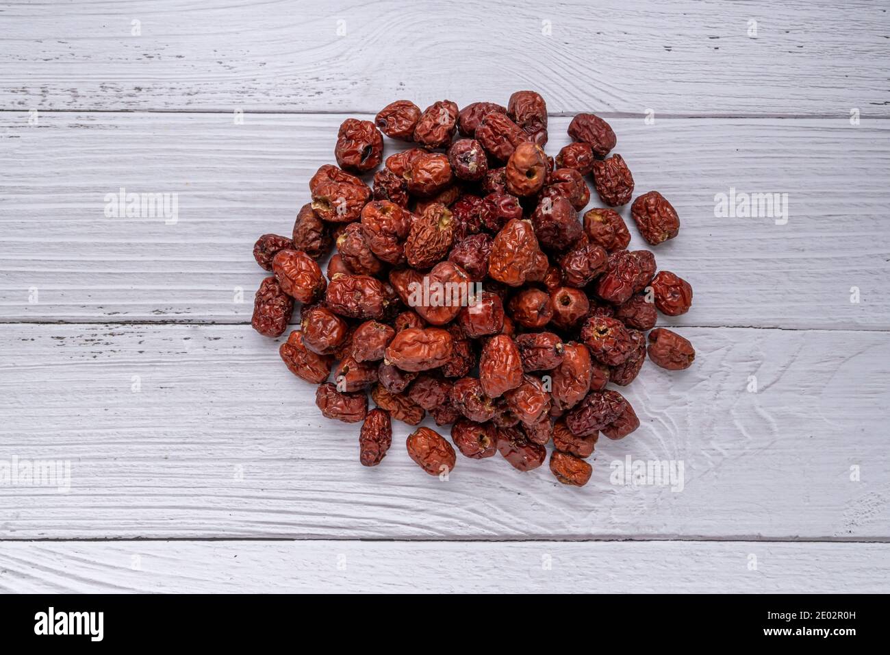 Dried jujube on white wood background. The fruit is a traditional ...