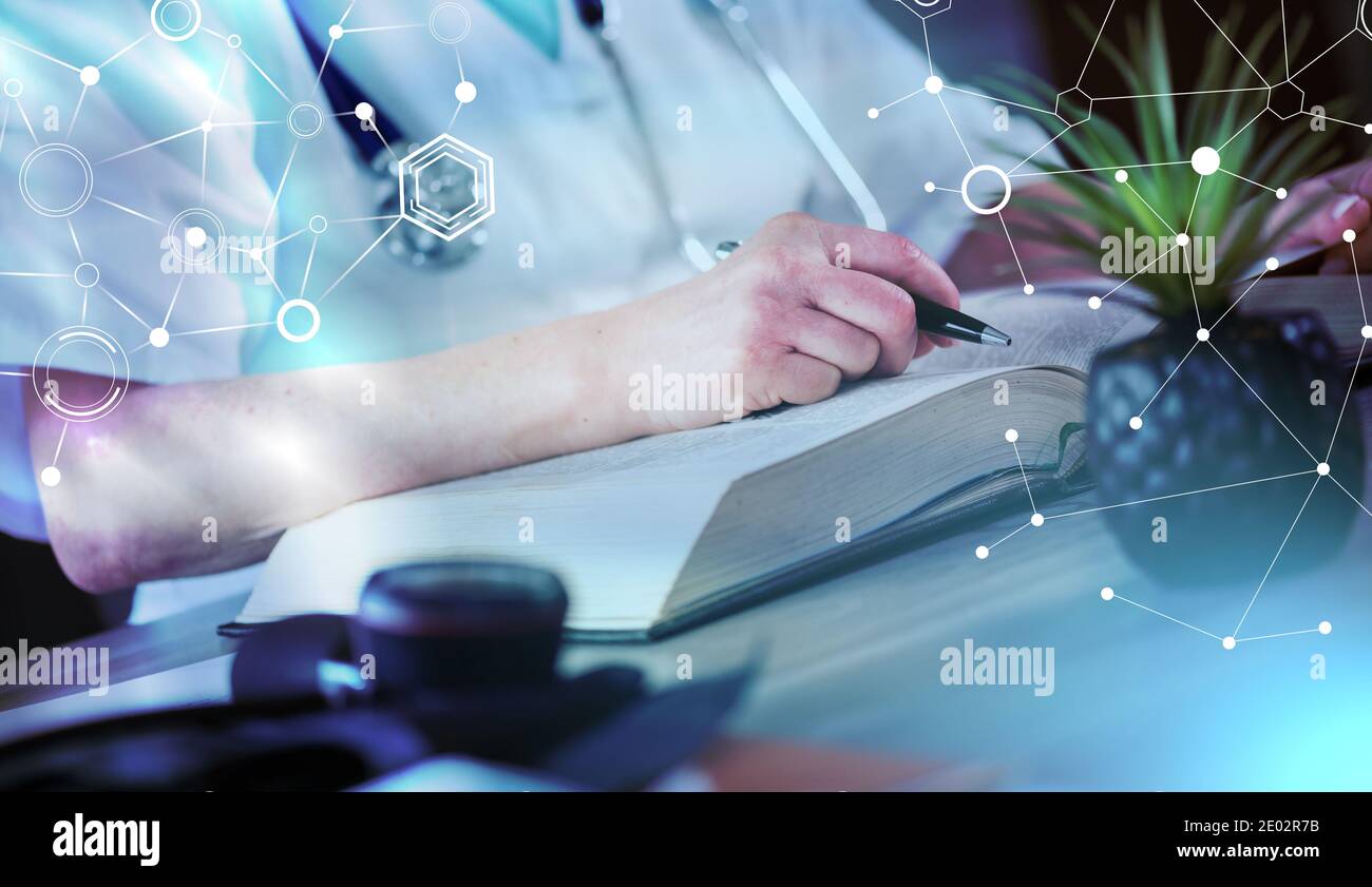 Female doctor reading a textbook in medical office; light effect Stock ...