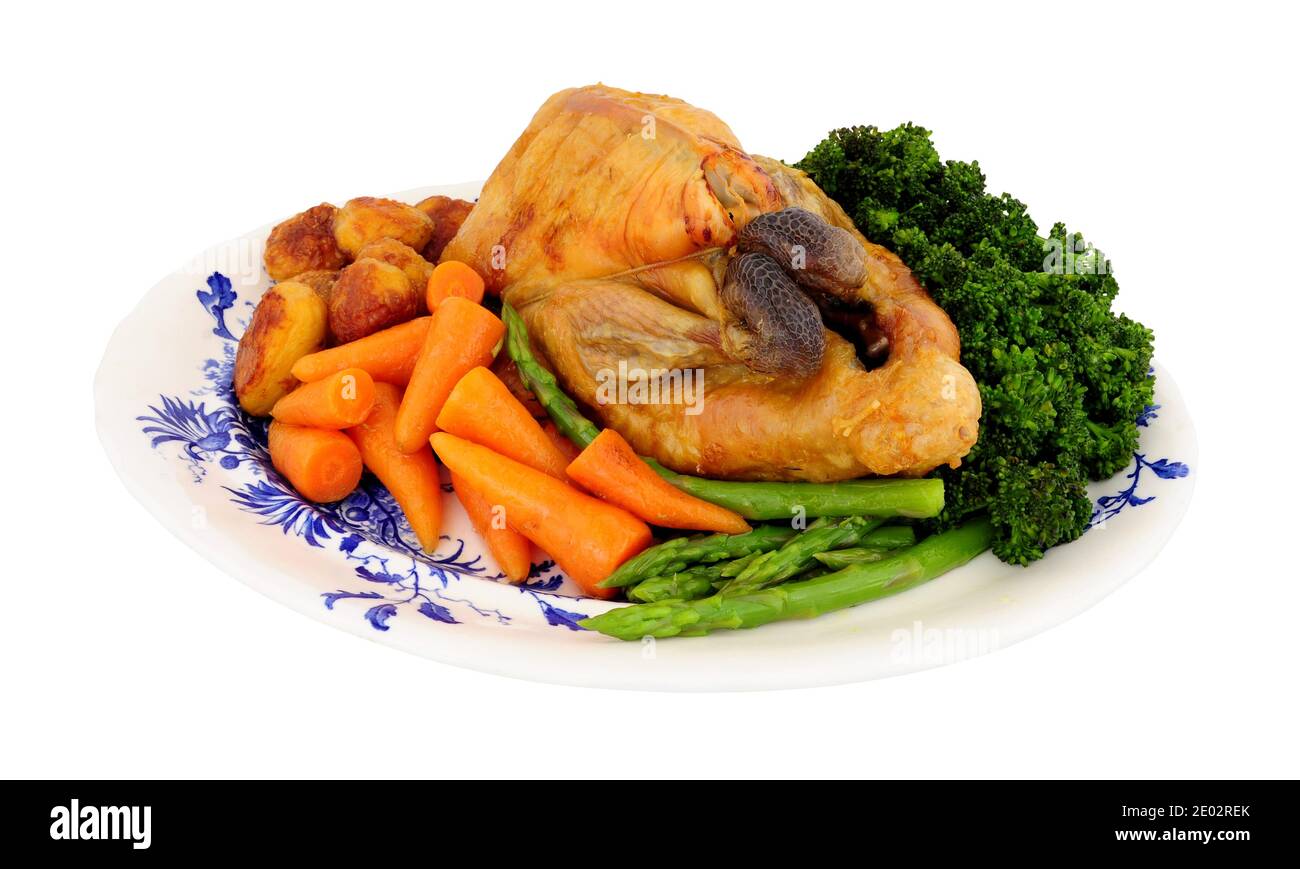 Roasted whole Guinea fowl with roast potatoes and fresh vegetables ...