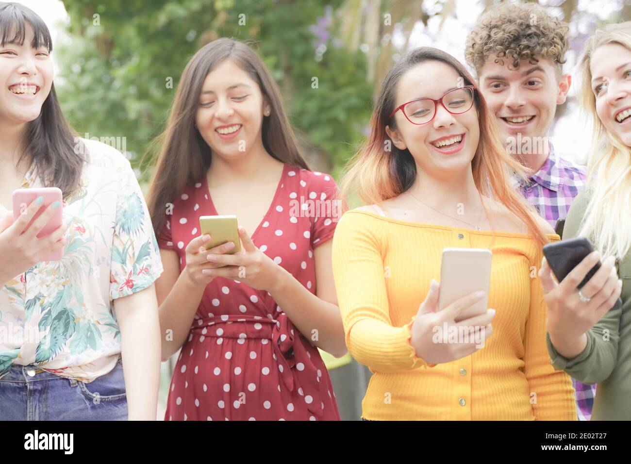 Happy friends using smartphones. Young students people having fun with ...