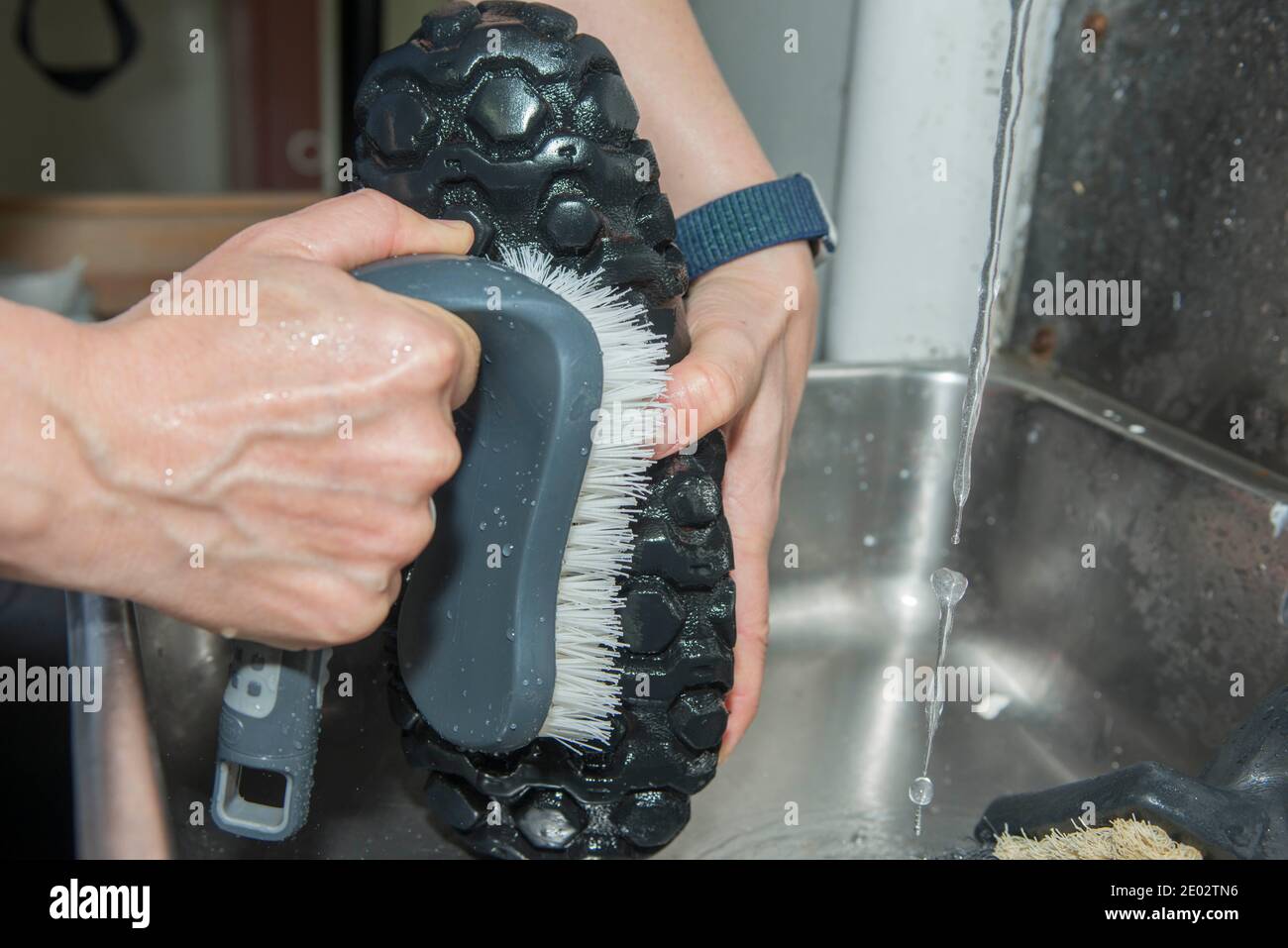Cleaning and checking boots for seeds and mud prior to landing on South ...