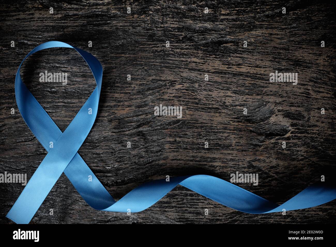 Top view of light blue ribbon on wooden background with copy space. Men ...
