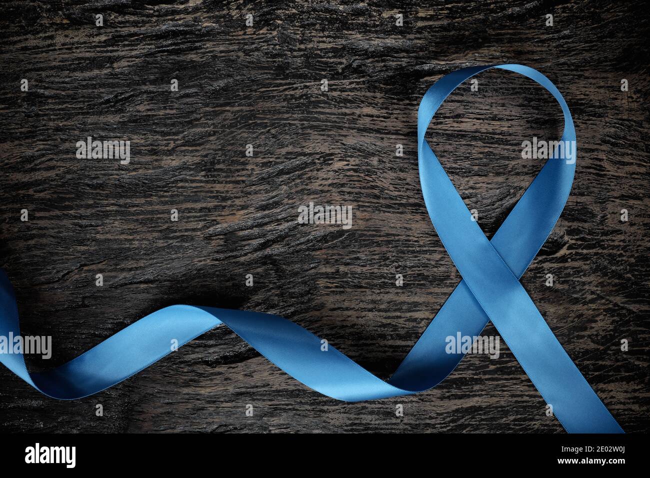 Top view of light blue ribbon on wooden background with copy space. Men ...