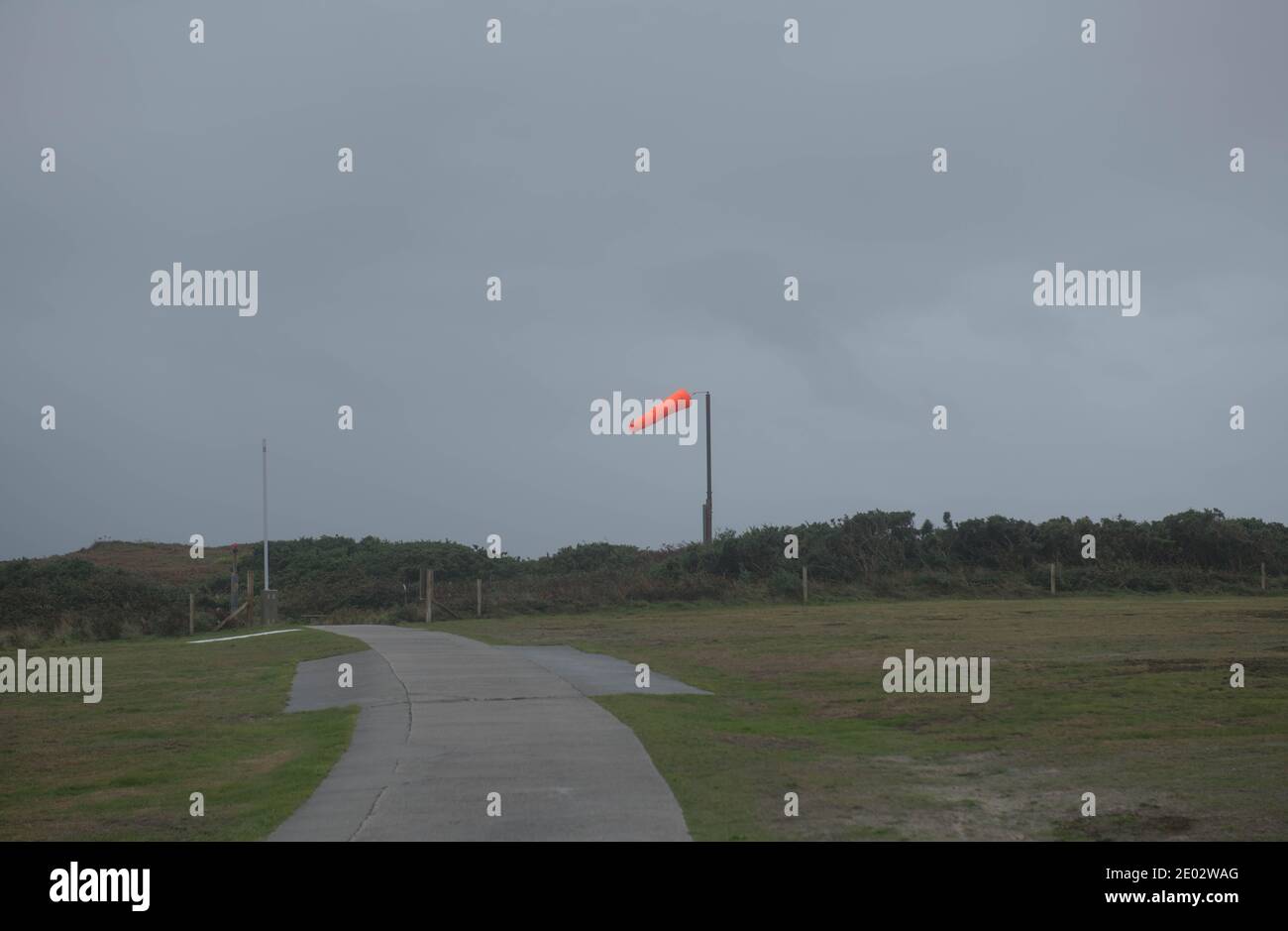 Bright Orange Windsock Blowing in the Wind on an Overcast Cloudy Day at ...
