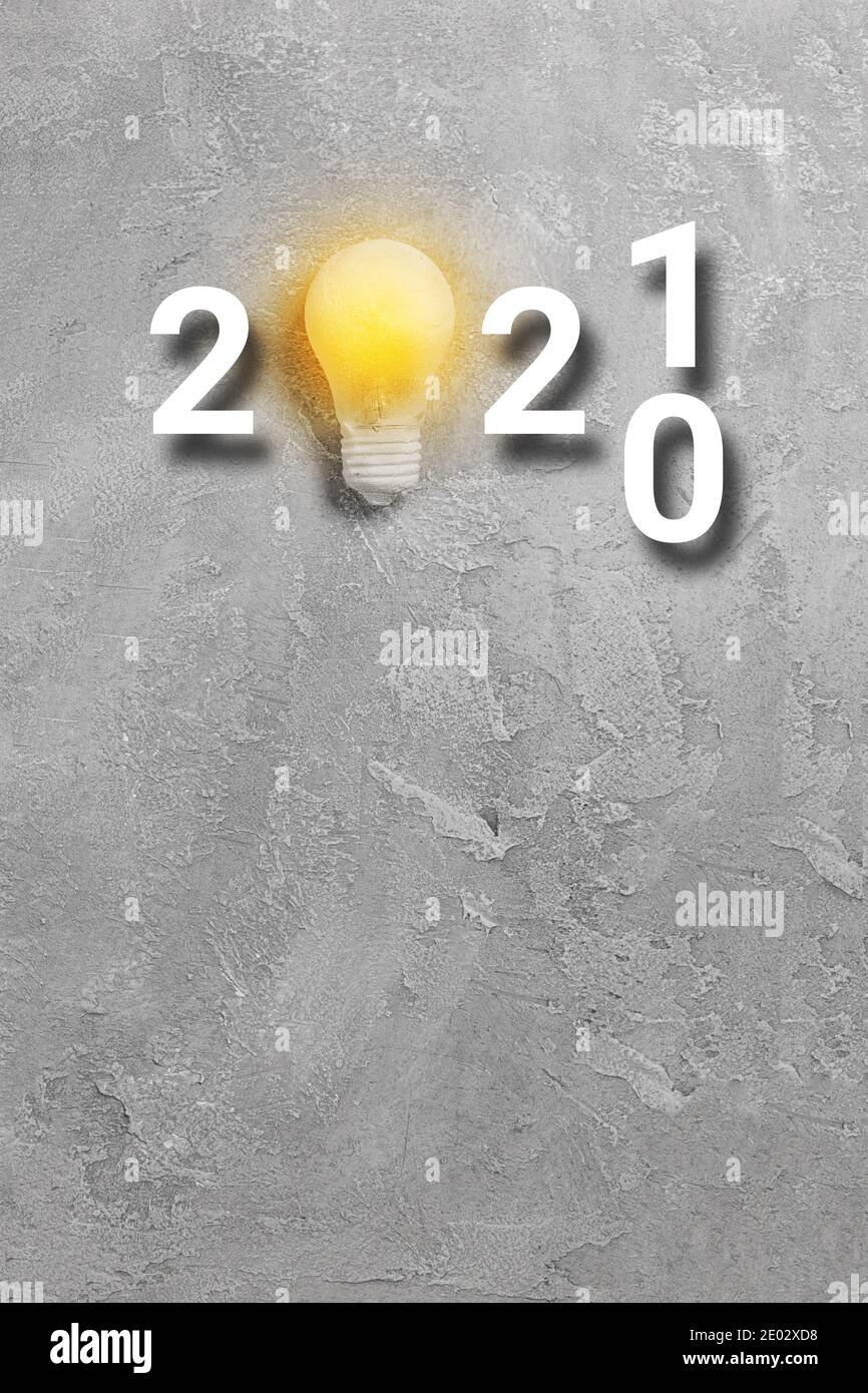 Light yelow bulb idea with 2021 new year text on a grey background ...