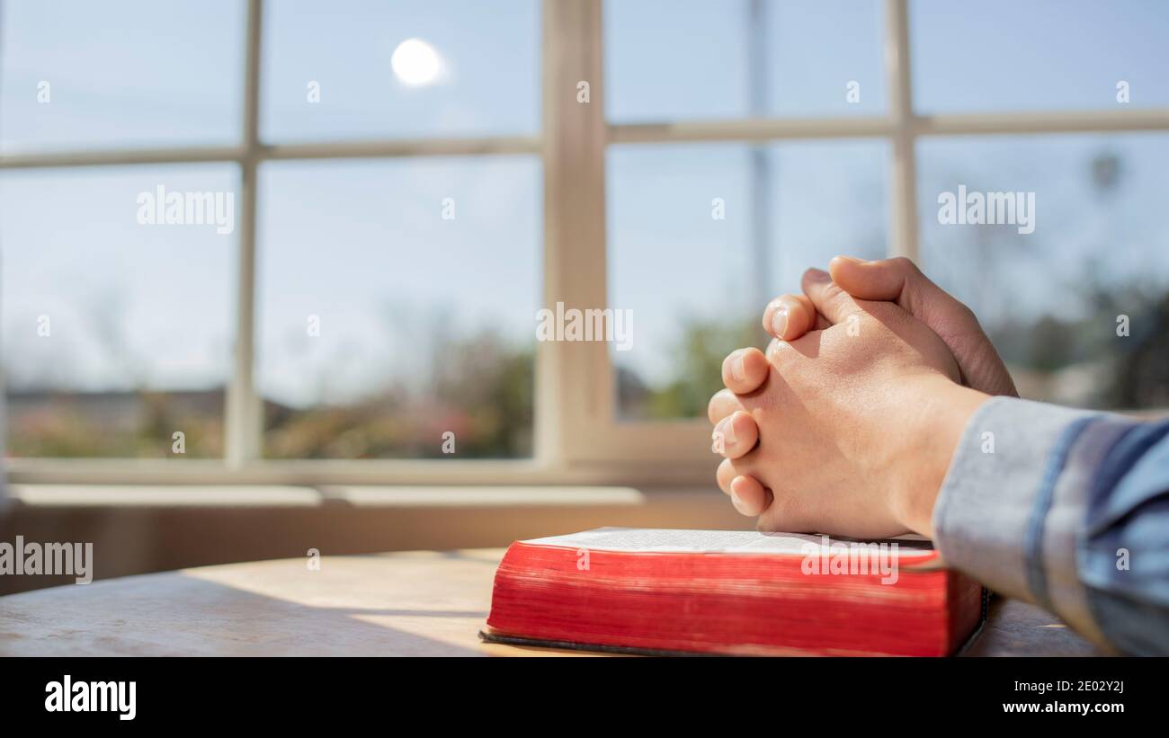 Coronavirus, isolation, reading the Bible and praying by the window at ...