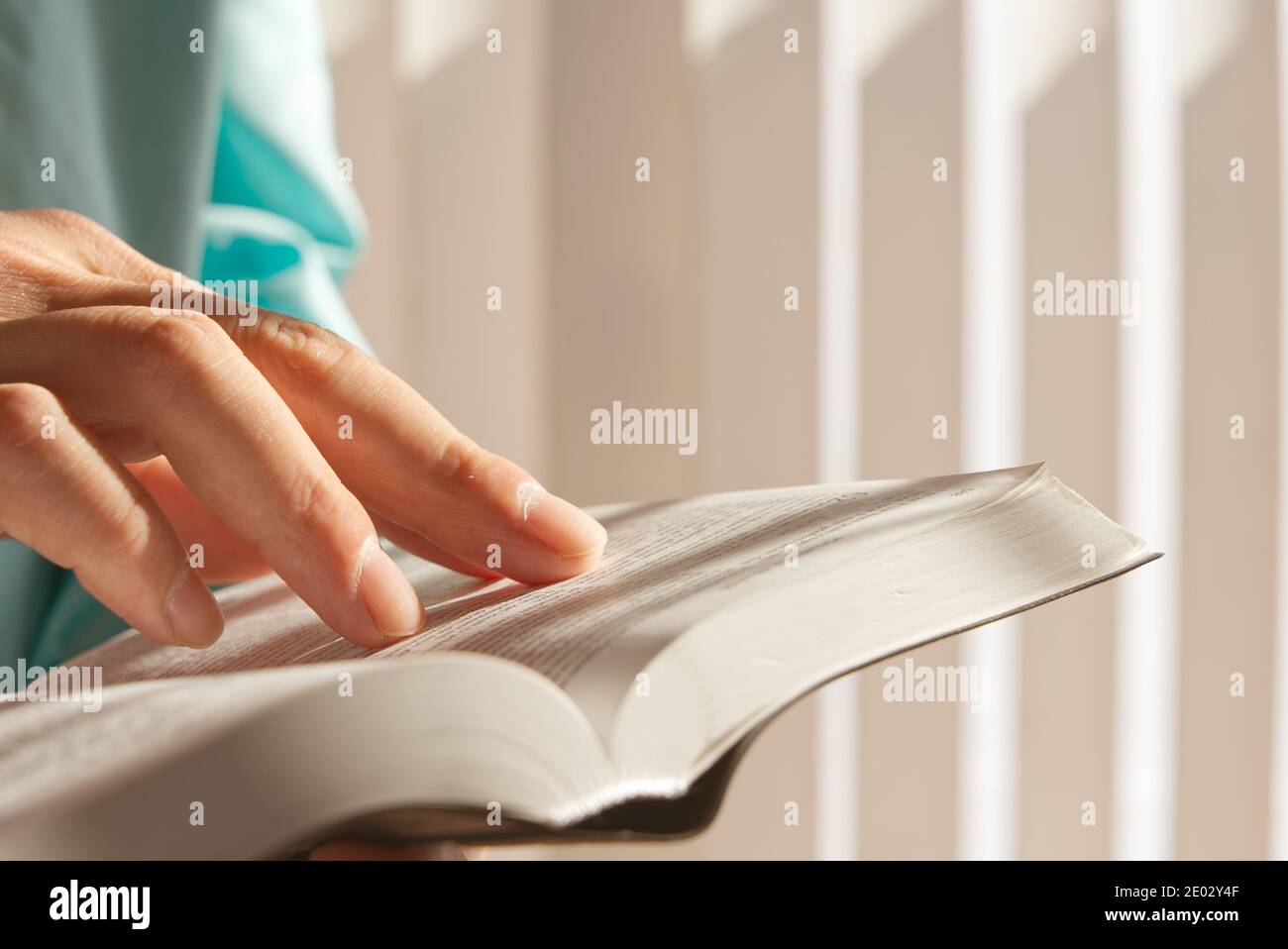 Closeup of man's hands and an open bible, reading the Bible at home ...