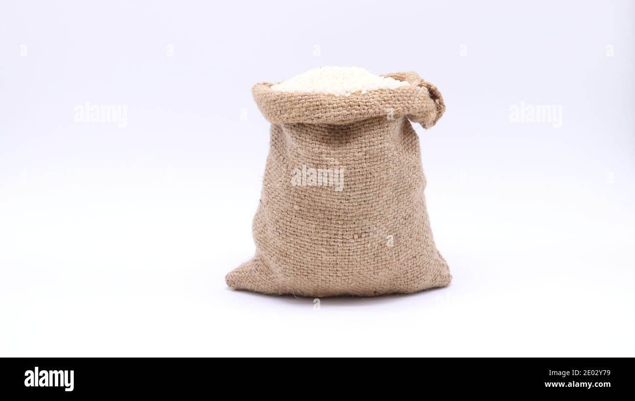 Closeup of white rice in a brown burlap sack isolated on white ...