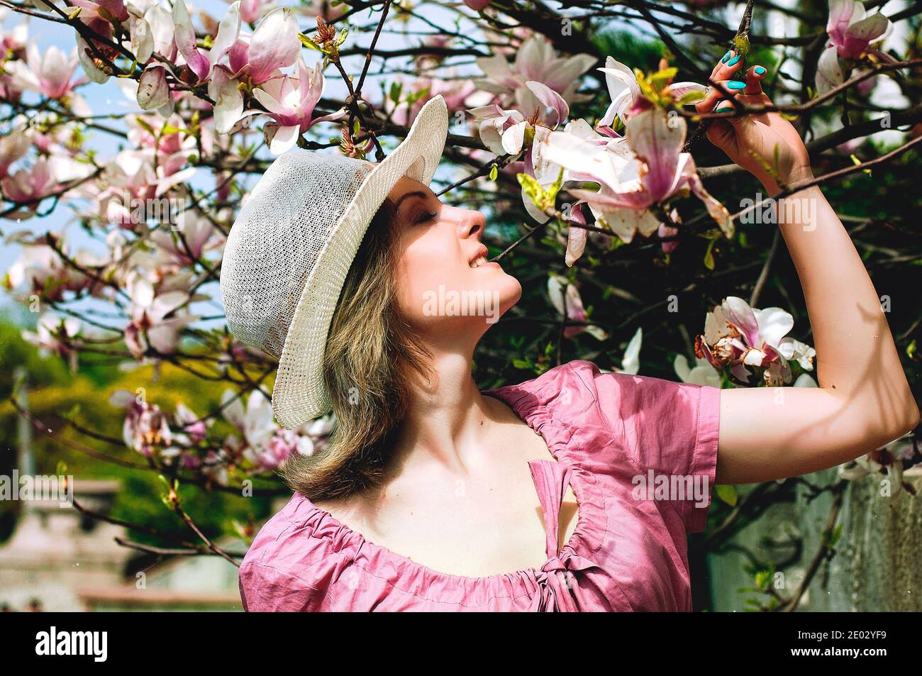 Portrait of young attractive woman in spring garden with blooming ...